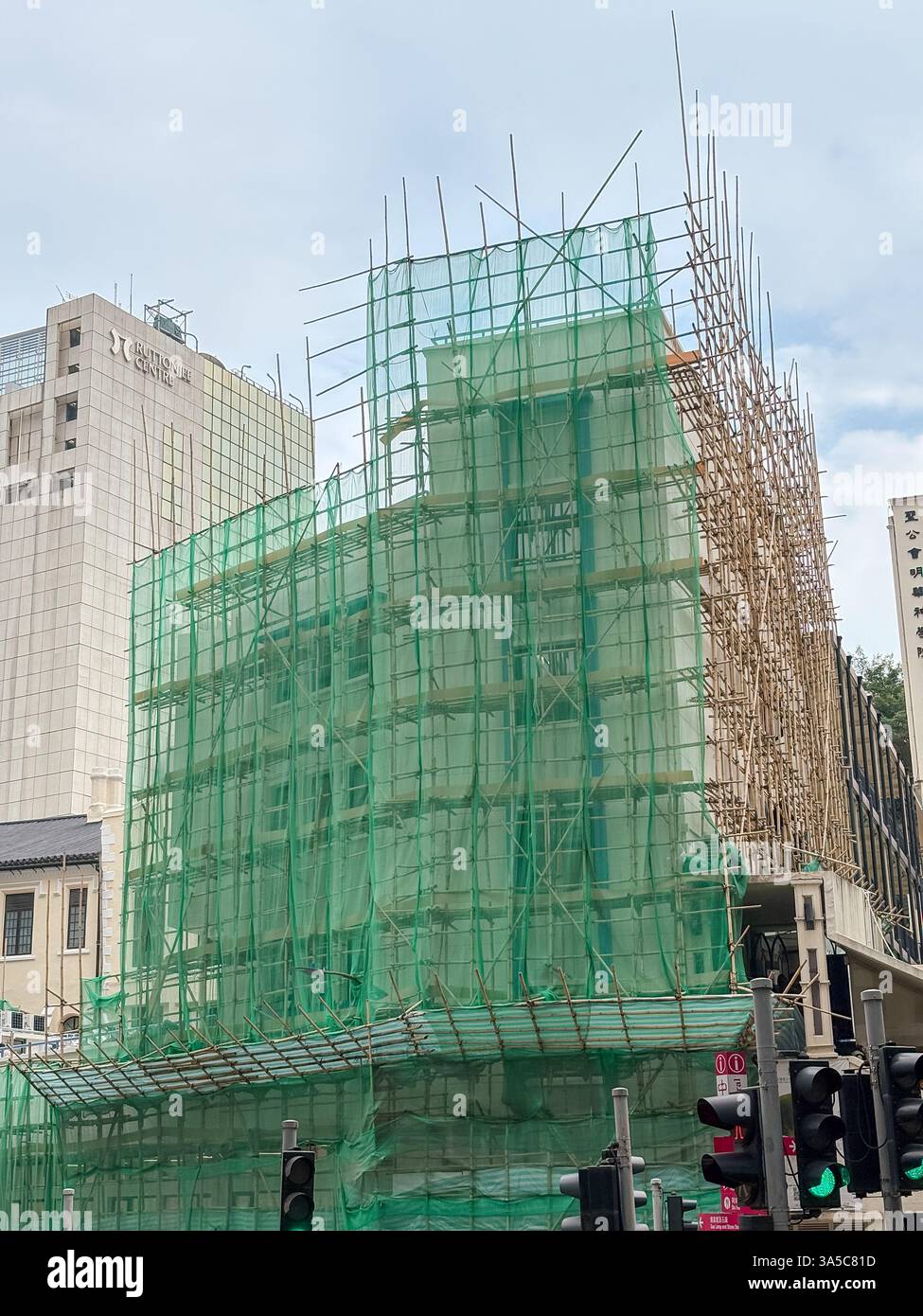 Building in Hong Kong with traditional bamboo scaffolding and safety ...