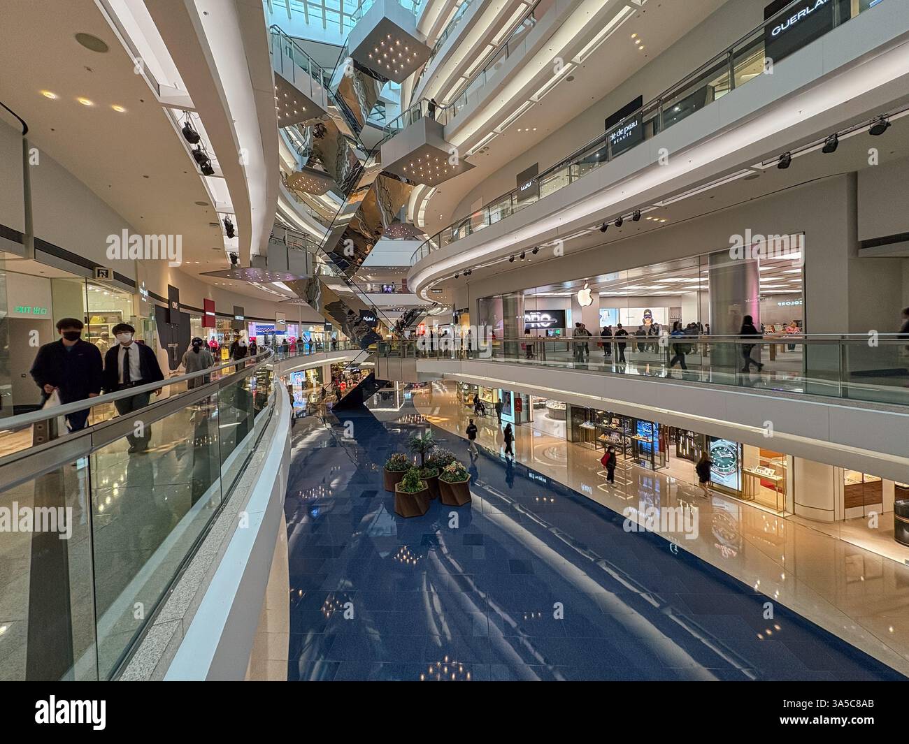 An overview of a luxury mall in Hong Kong with shoppers, high end brand ...