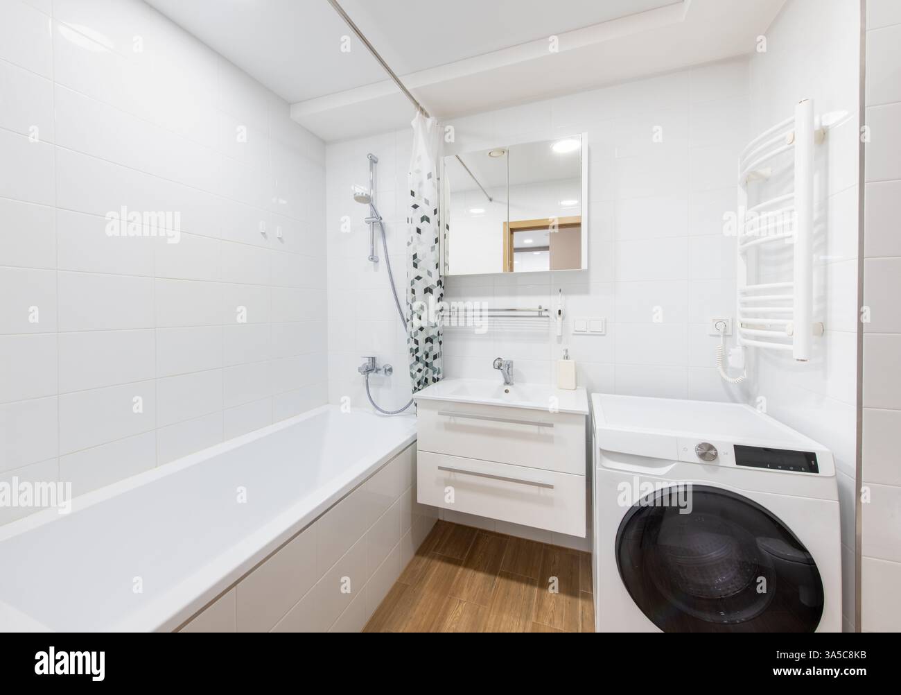 Bright and contemporary bathroom design featuring a bathtub, washing ...