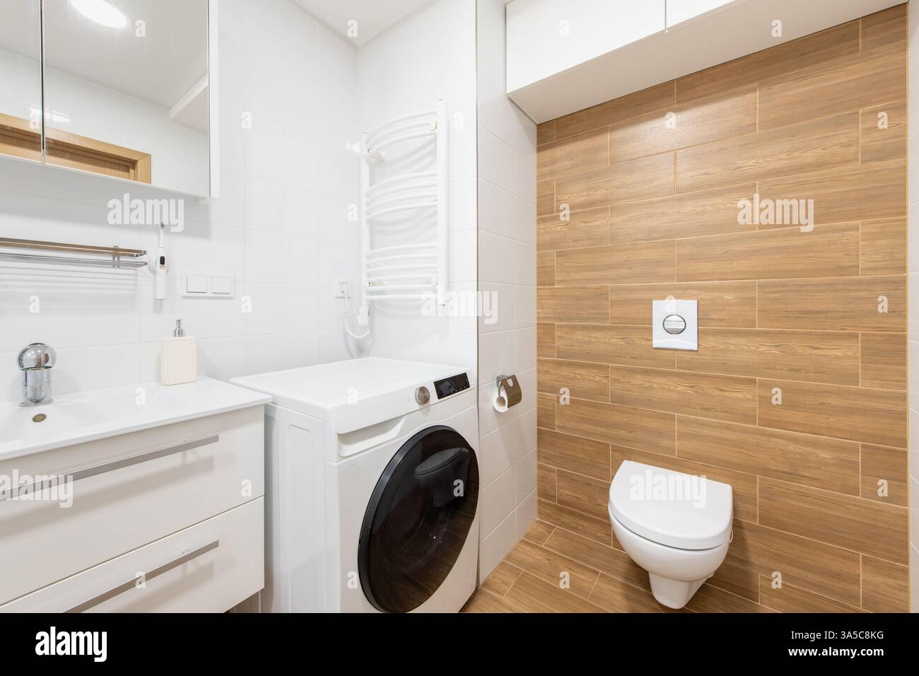 Bright and contemporary washroom interior showcasing a washing machine ...
