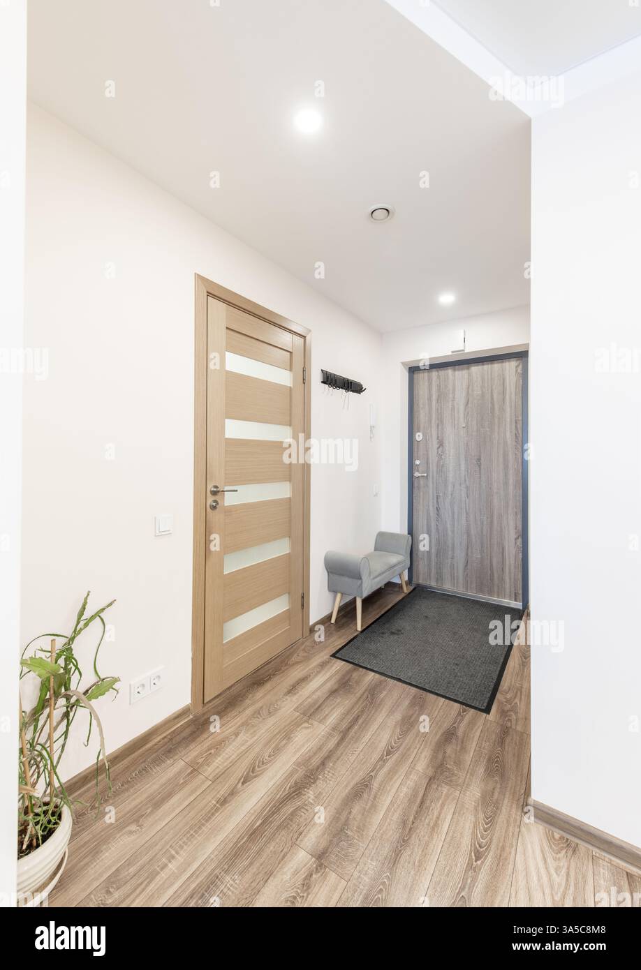 Bright and clean home entryway featuring wooden flooring, functional ...