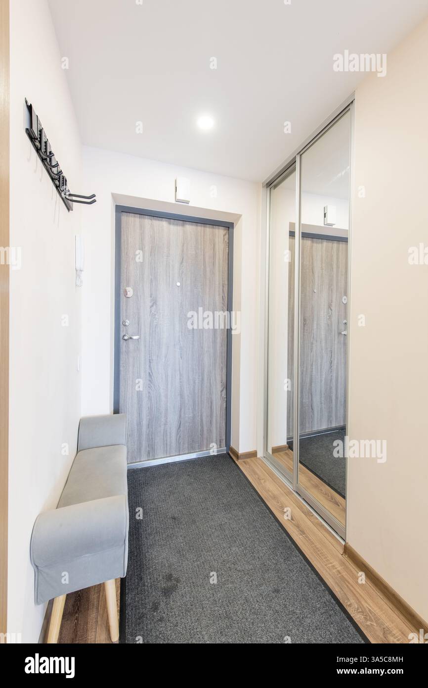 Bright and clean home entryway featuring wooden flooring, functional ...