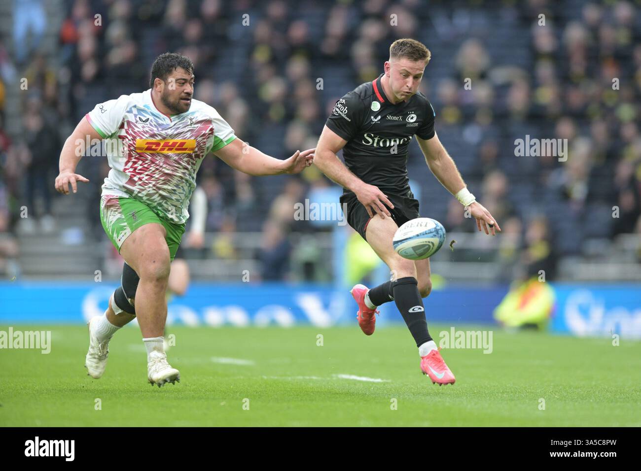 Fergus Burke of Saracens kicks the ball forward during the Gallagher ...