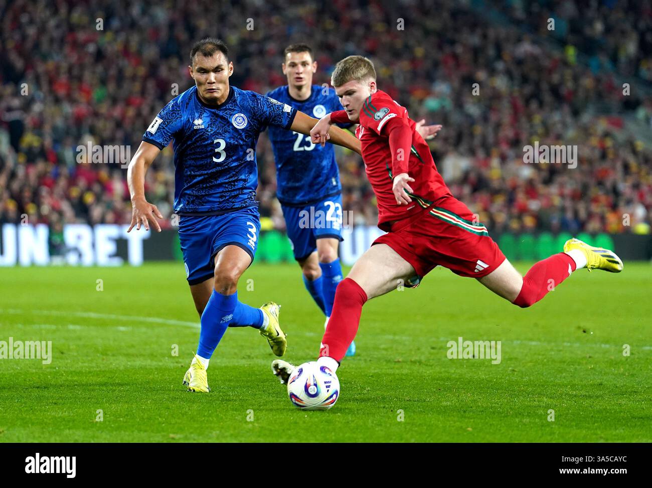 Wales' Jordan James (right) attempts a shot past Kazakhstan's Nuraly ...