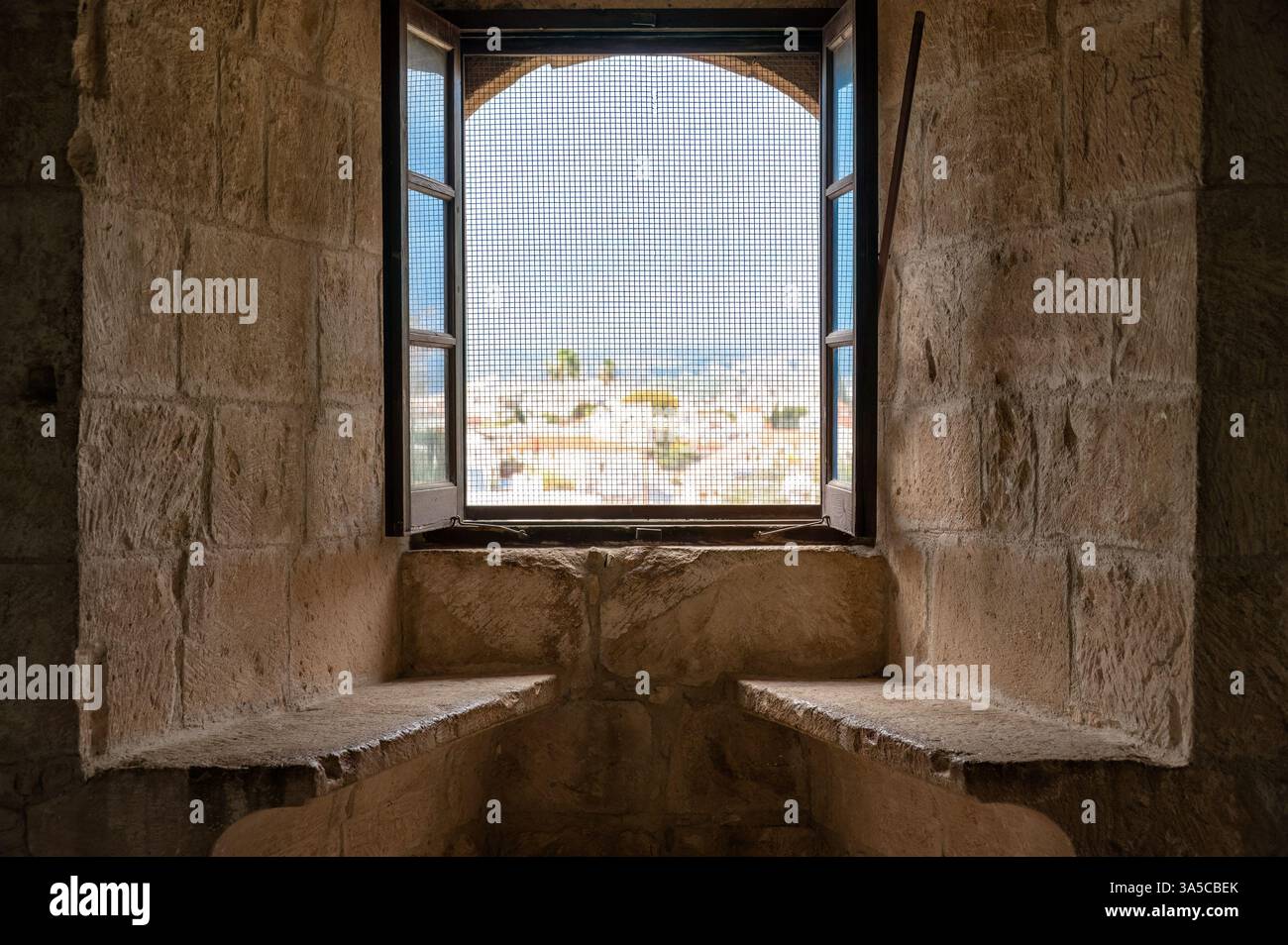 Open window with insect screen showing cityscape view from Kolossi ...