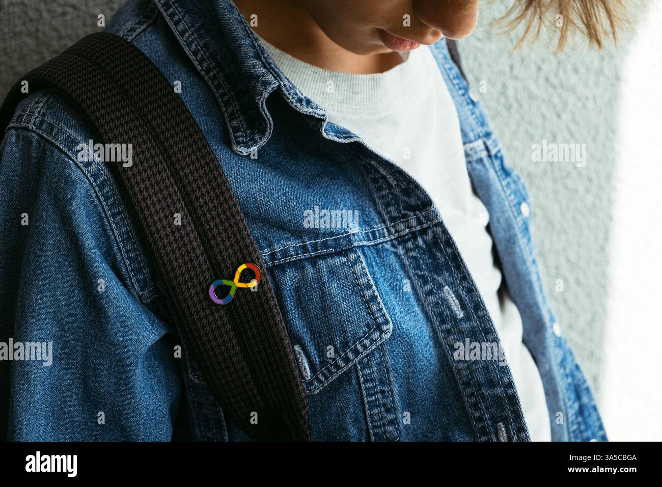 Teenage boy with autism infinity rainbow symbol sign. World autism ...
