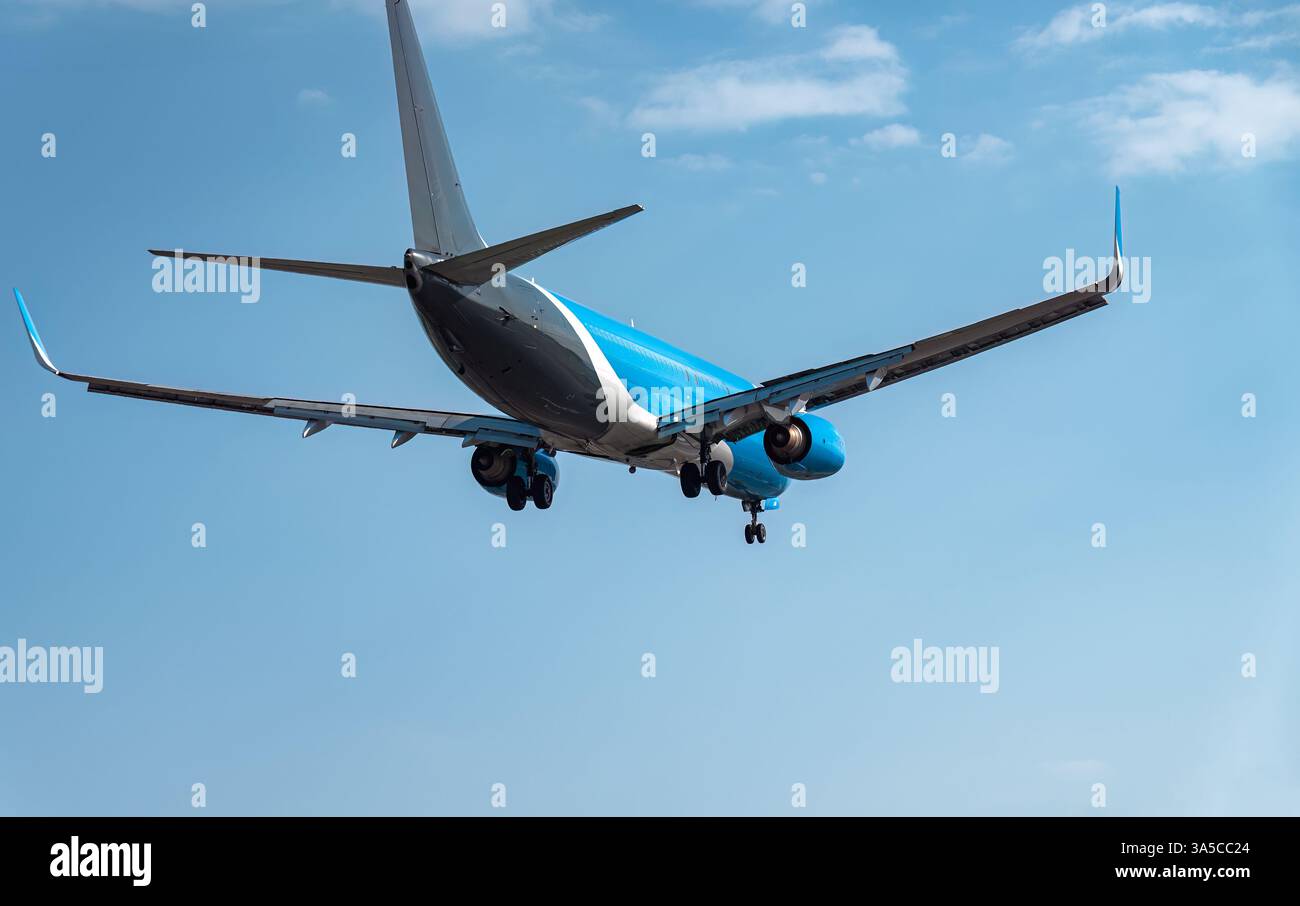 Large passenger airplane is approaching an airport runway, preparing ...