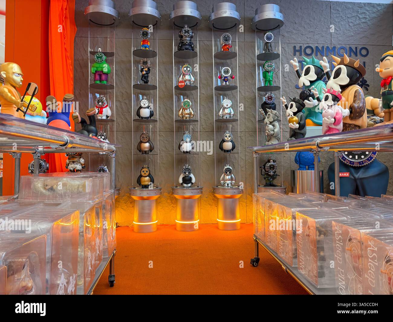 Display at Honmono Tokyo shows various figures in glass shelves and ...