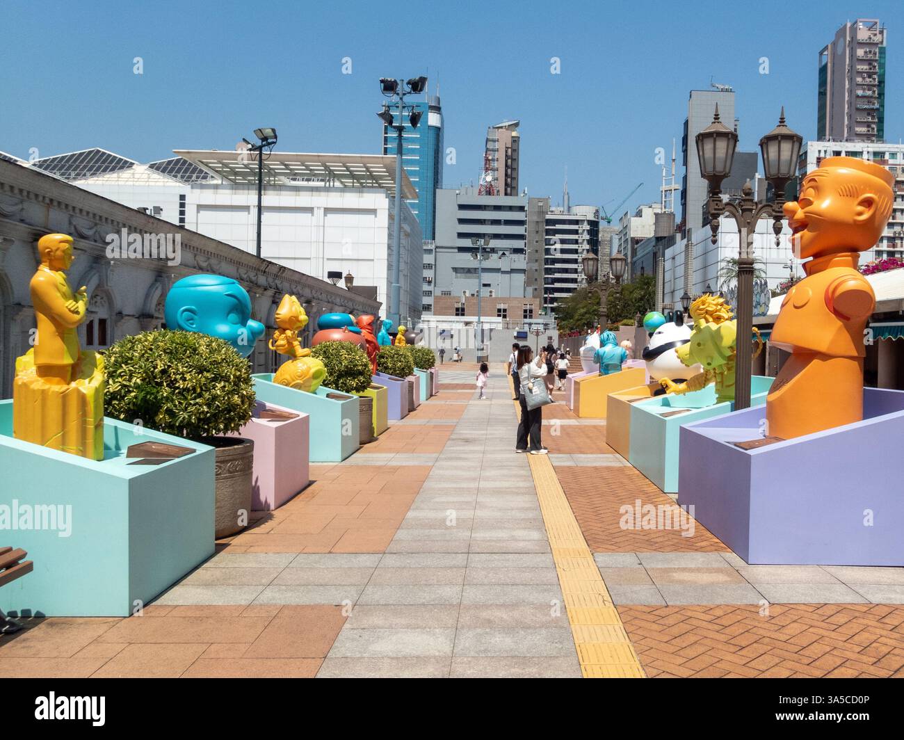 A visitor seen taking a photo of a cartoon character at the Hong Kong ...