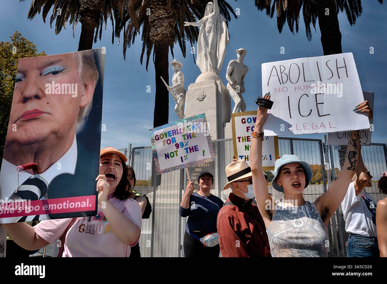 Protesters carry signs and shout slogans against the policies of ...