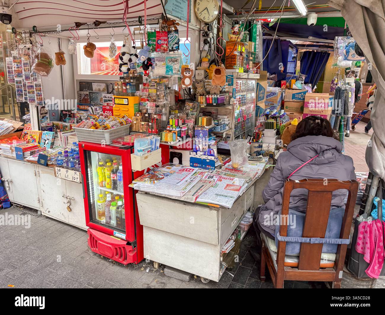 A small and very full newspaper vendor stall in Hong Kong, with the ...