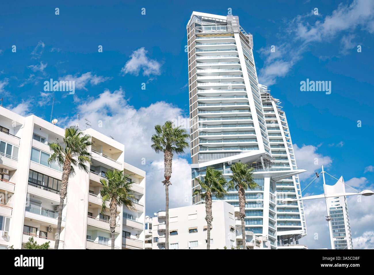 Modern skyscraper is being built, towering over traditional buildings ...