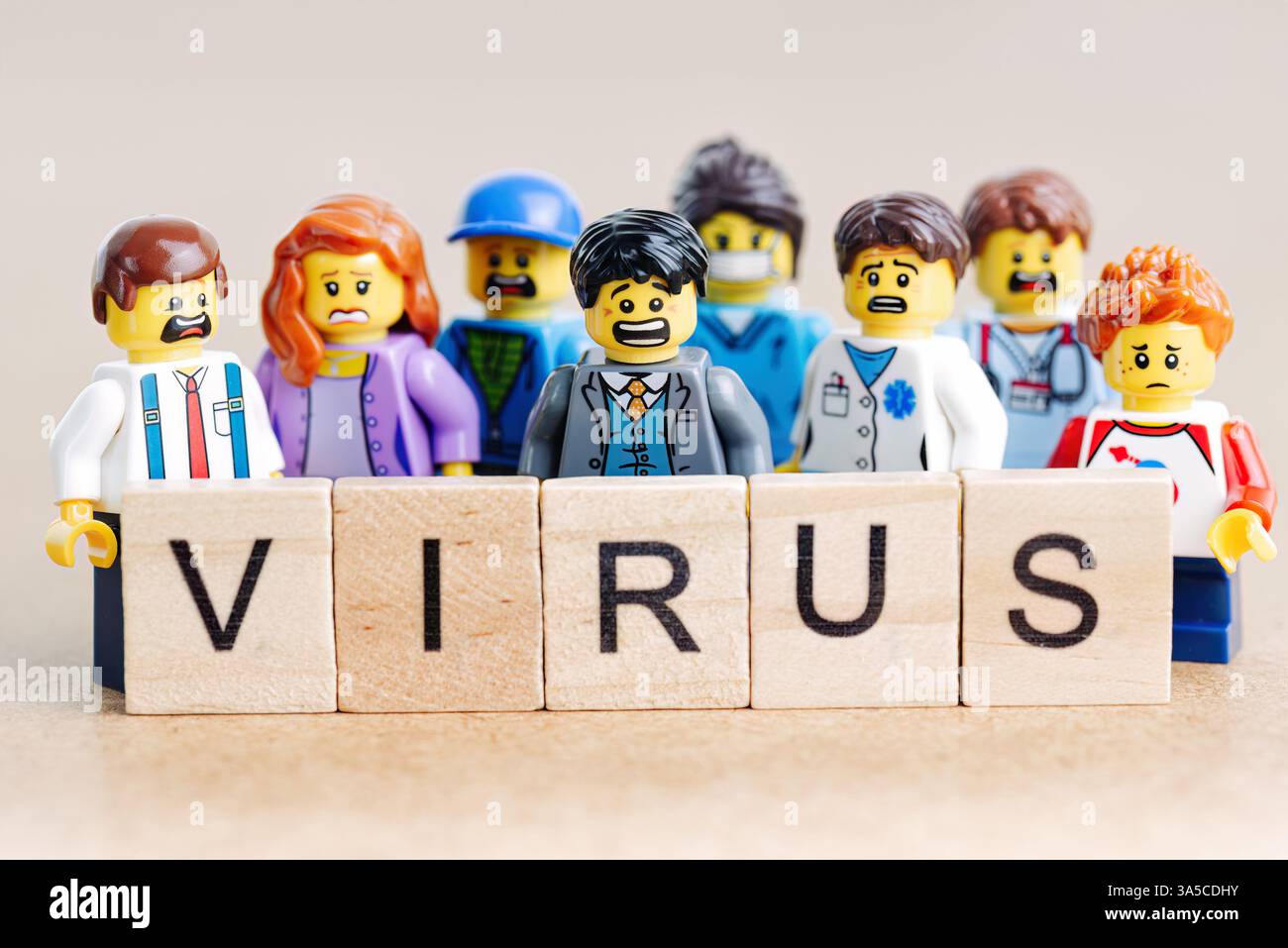 Group of concerned lego people standing behind scrabble tiles spelling ...