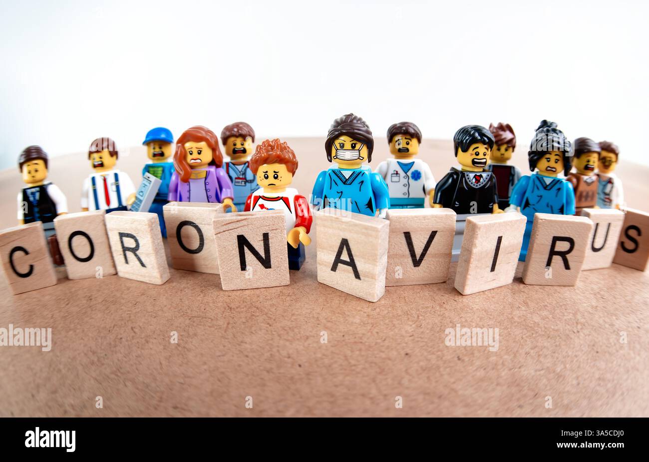 Group of concerned people are standing behind the word coronavirus ...