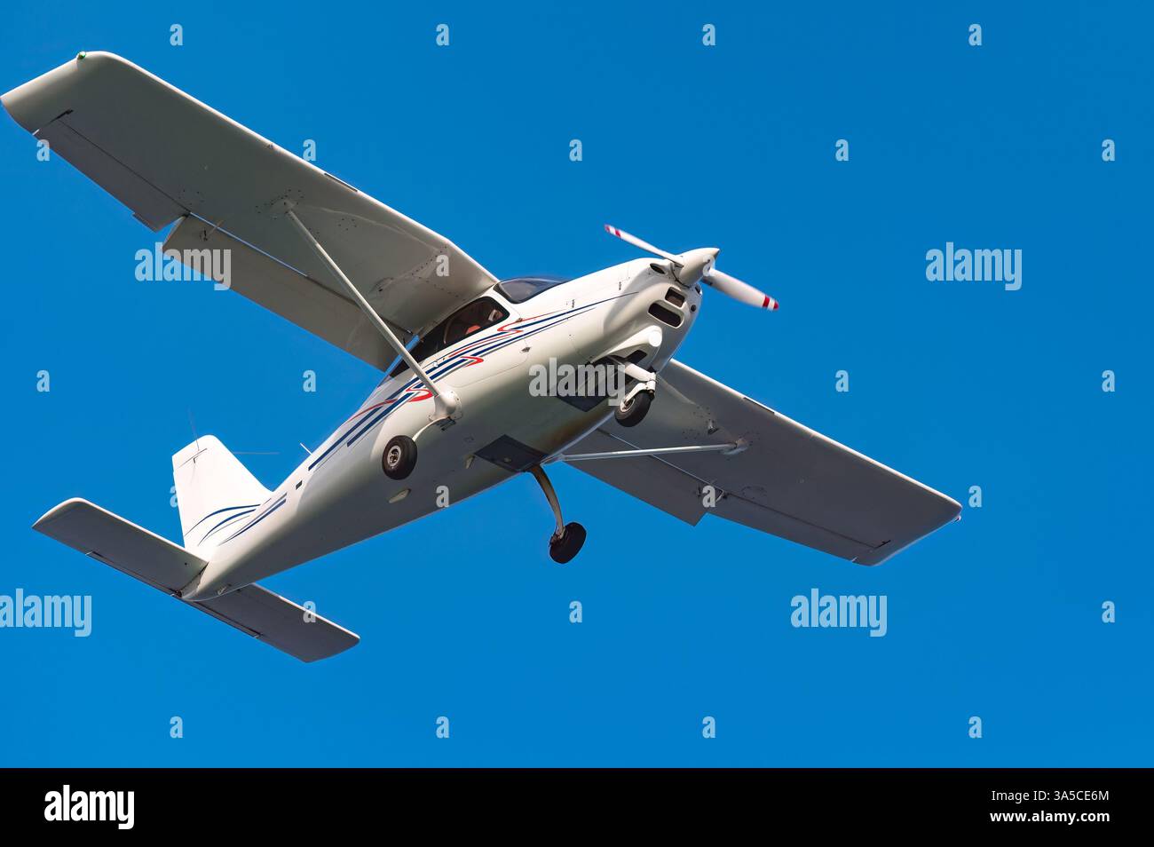 Small airplane soaring through the vast expanse of a vibrant blue sky ...