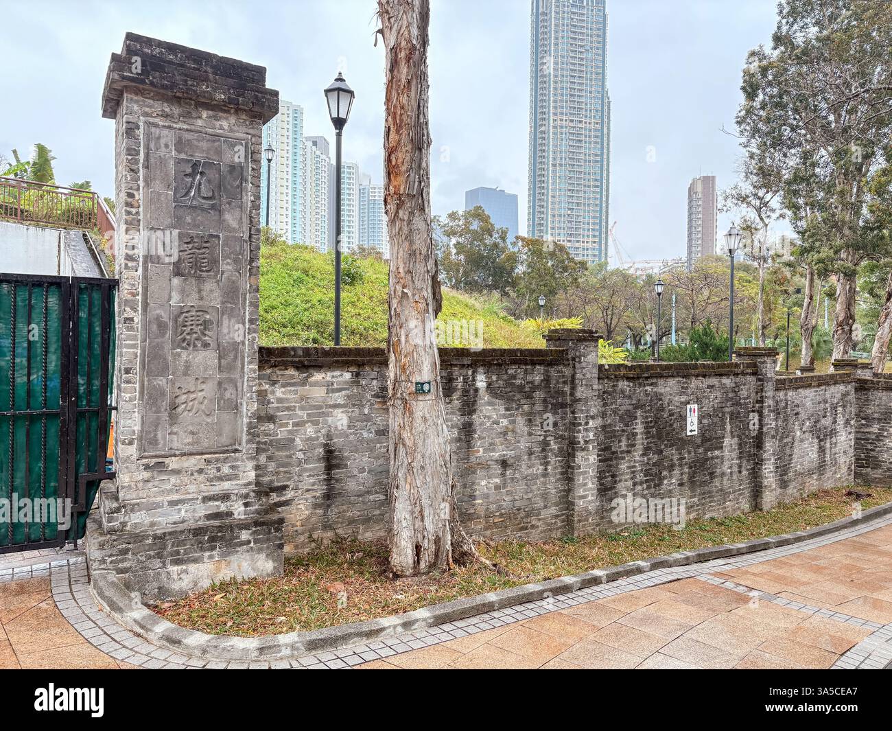Kowloon Walled City Park entrance area with stone gate, wall, and ...