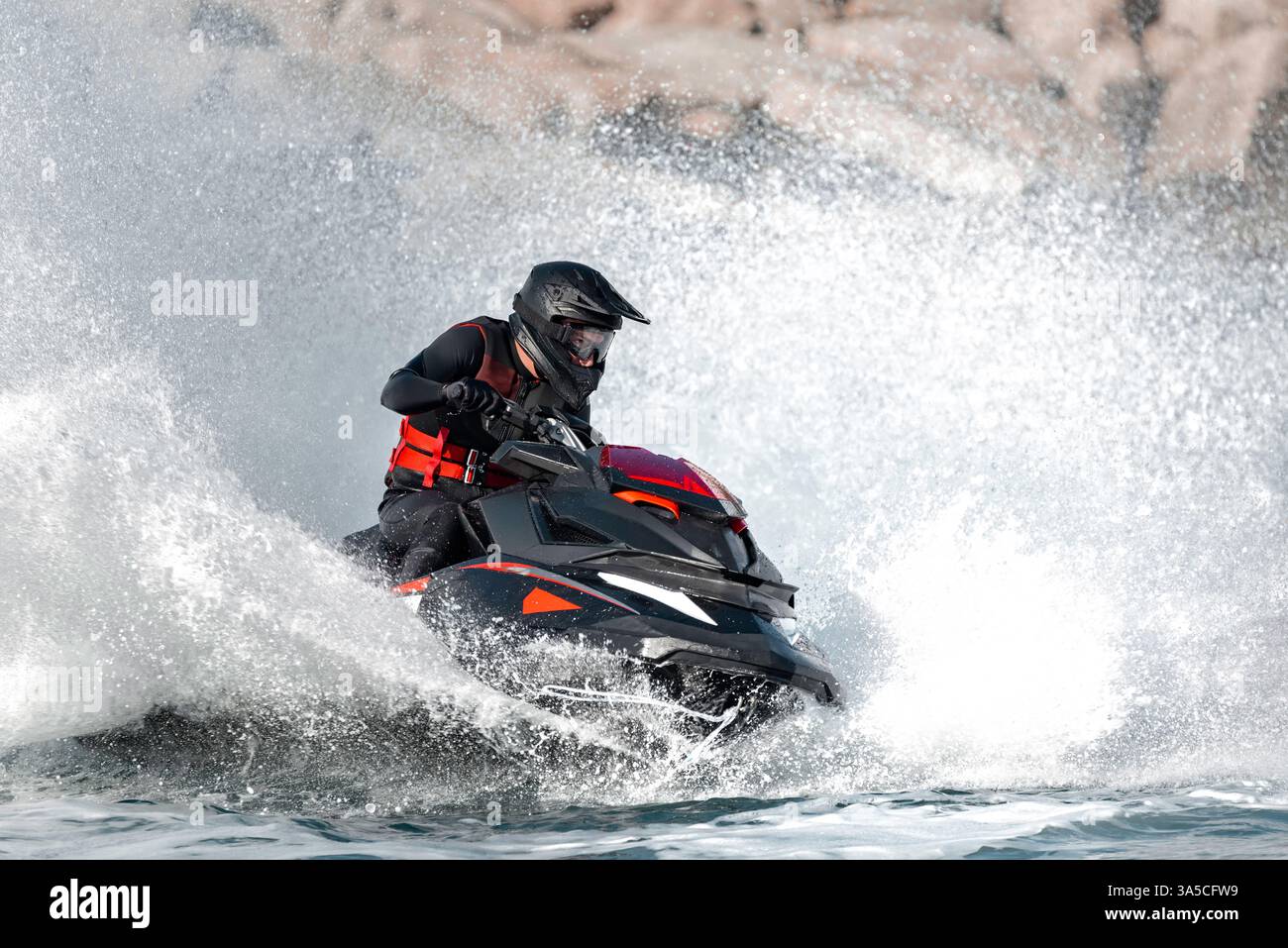 Professional athlete is riding a watercraft at high speed on the ocean ...