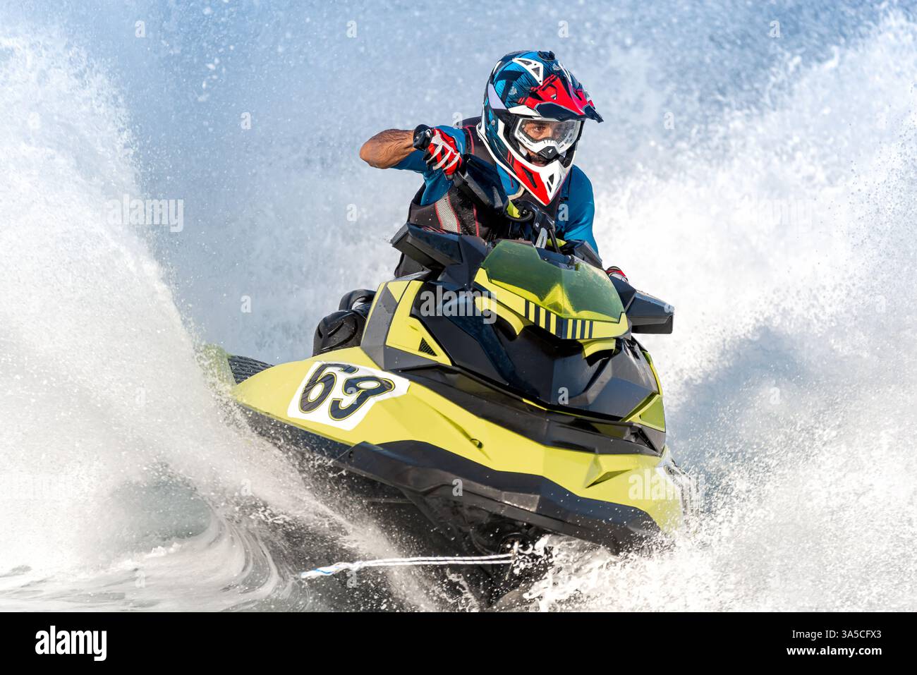 Professional racer is riding a yellow and black jet ski, leaving a ...
