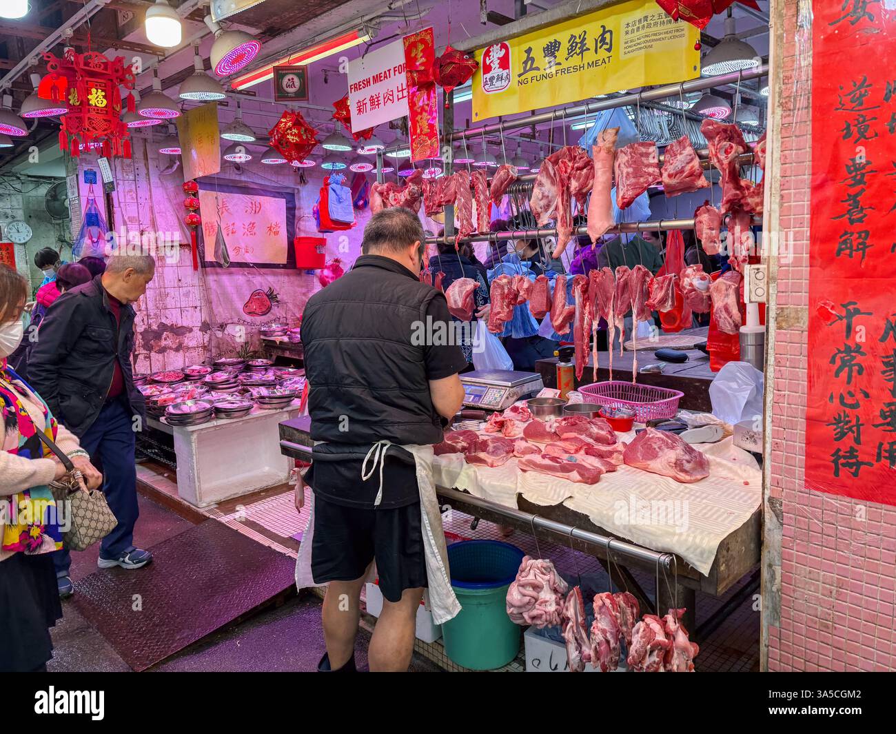 Meat market on Chun Yeung Street in North Point, Hong Kong. Customers ...