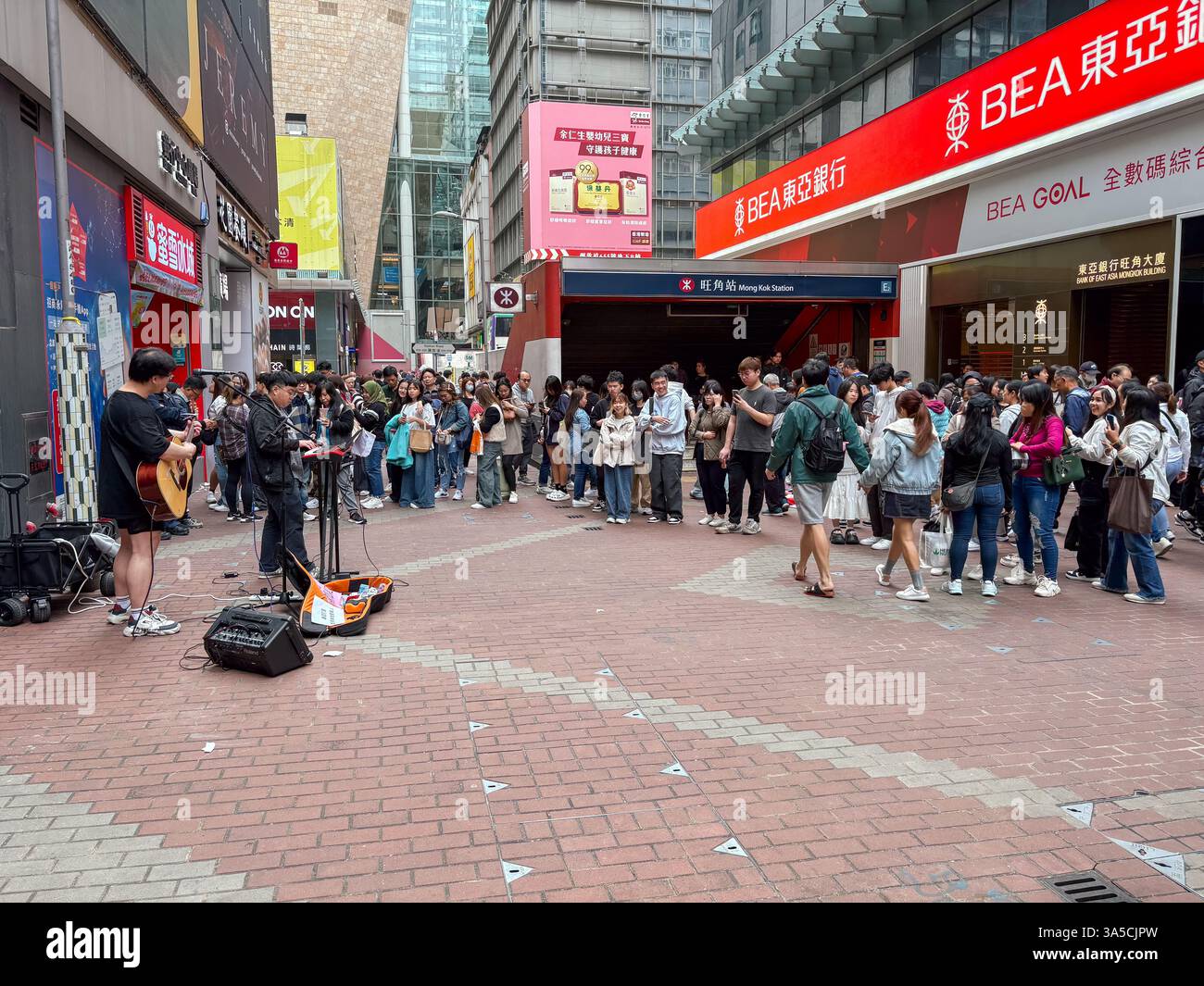 Street performers draw a crowd in Mong Kok, Hong Kong. Live music and ...