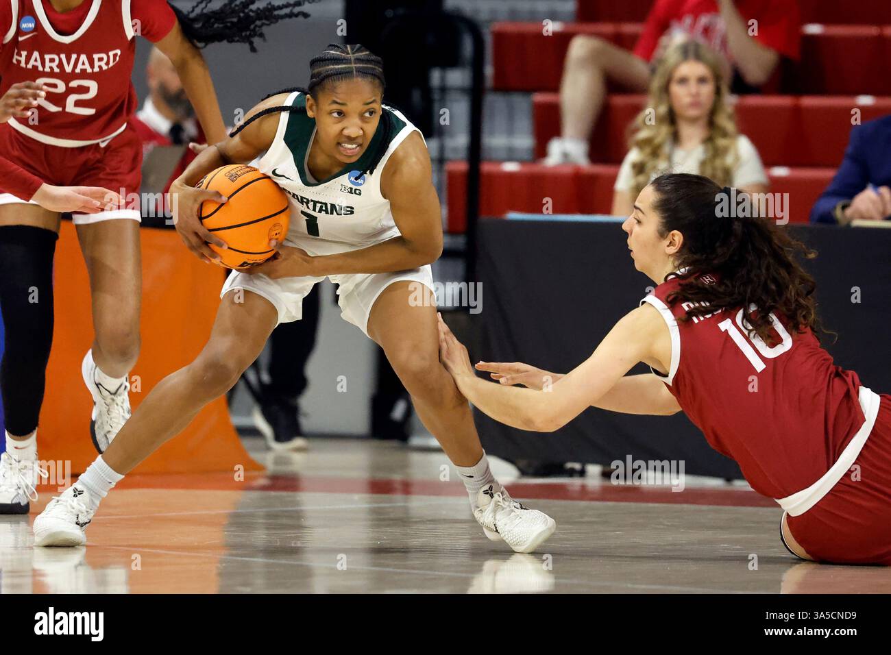 Michigan State's Jaddan Simmons (1) protects the ball from Harvard's ...