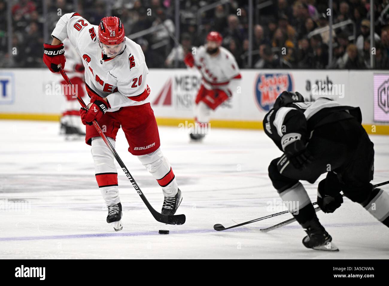 Carolina Hurricanes center Sebastian Aho (20) controls the puck past ...