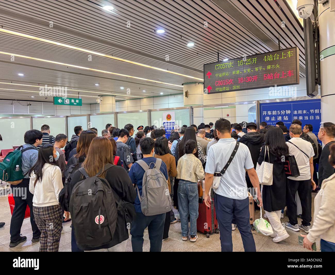 A crowded train station in Guangzhou, China. People waiting with ...