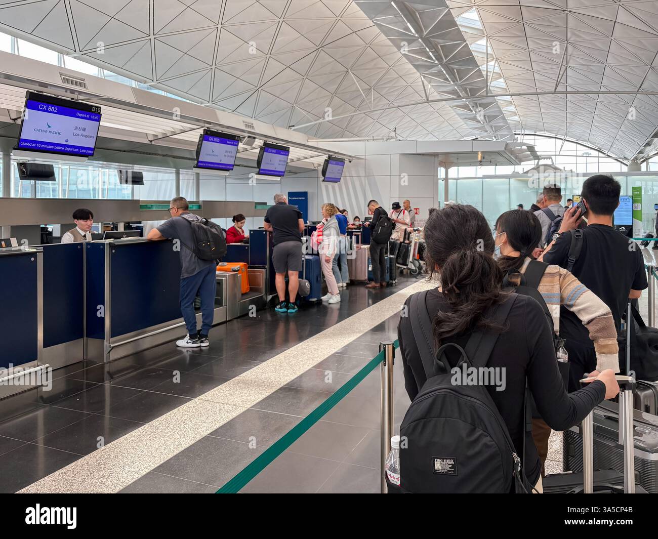 Check-in counter and passengers at Hong Kong International Airport ...