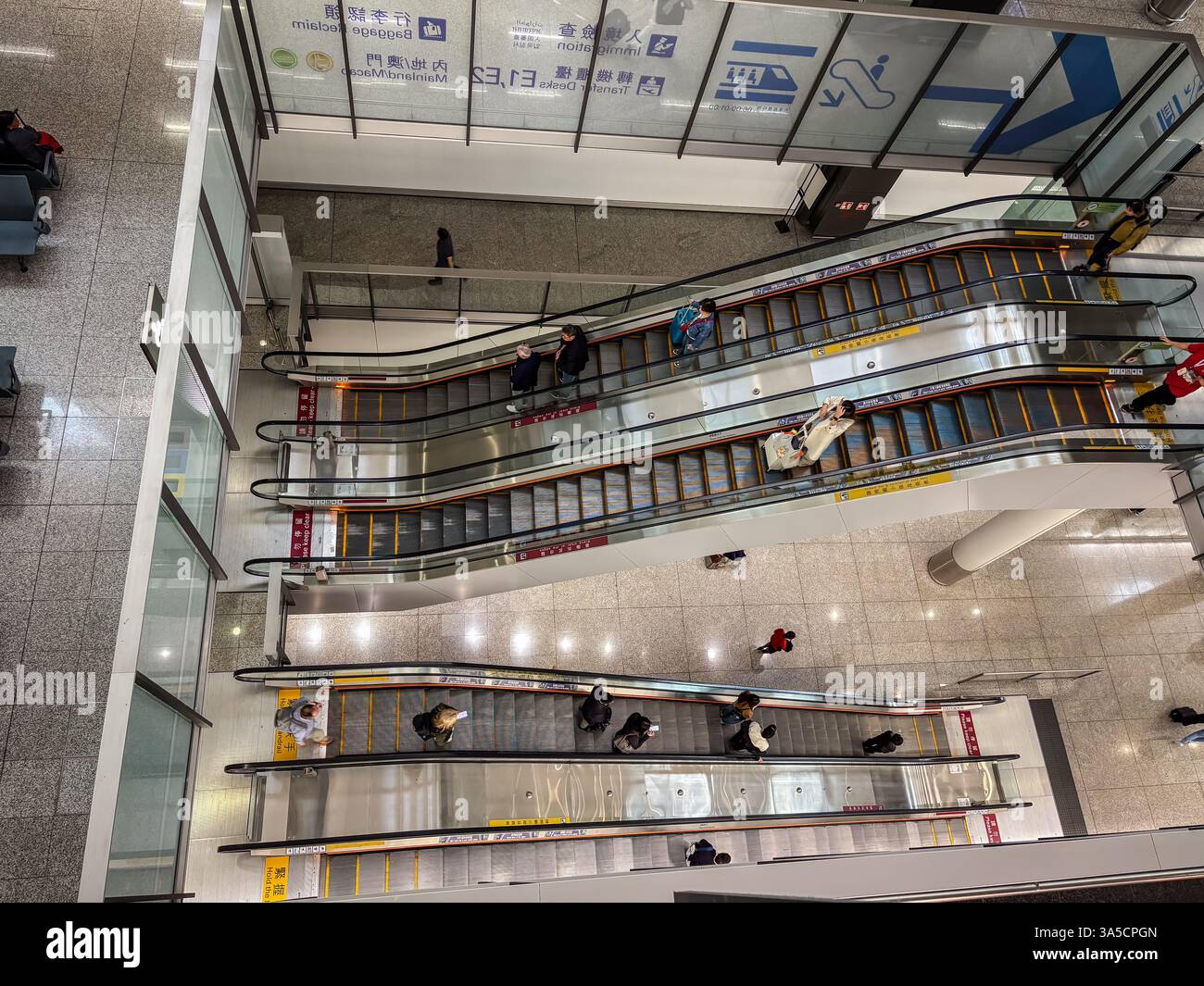 Top-down view of escalators at Hong Kong International Airport. Travel ...