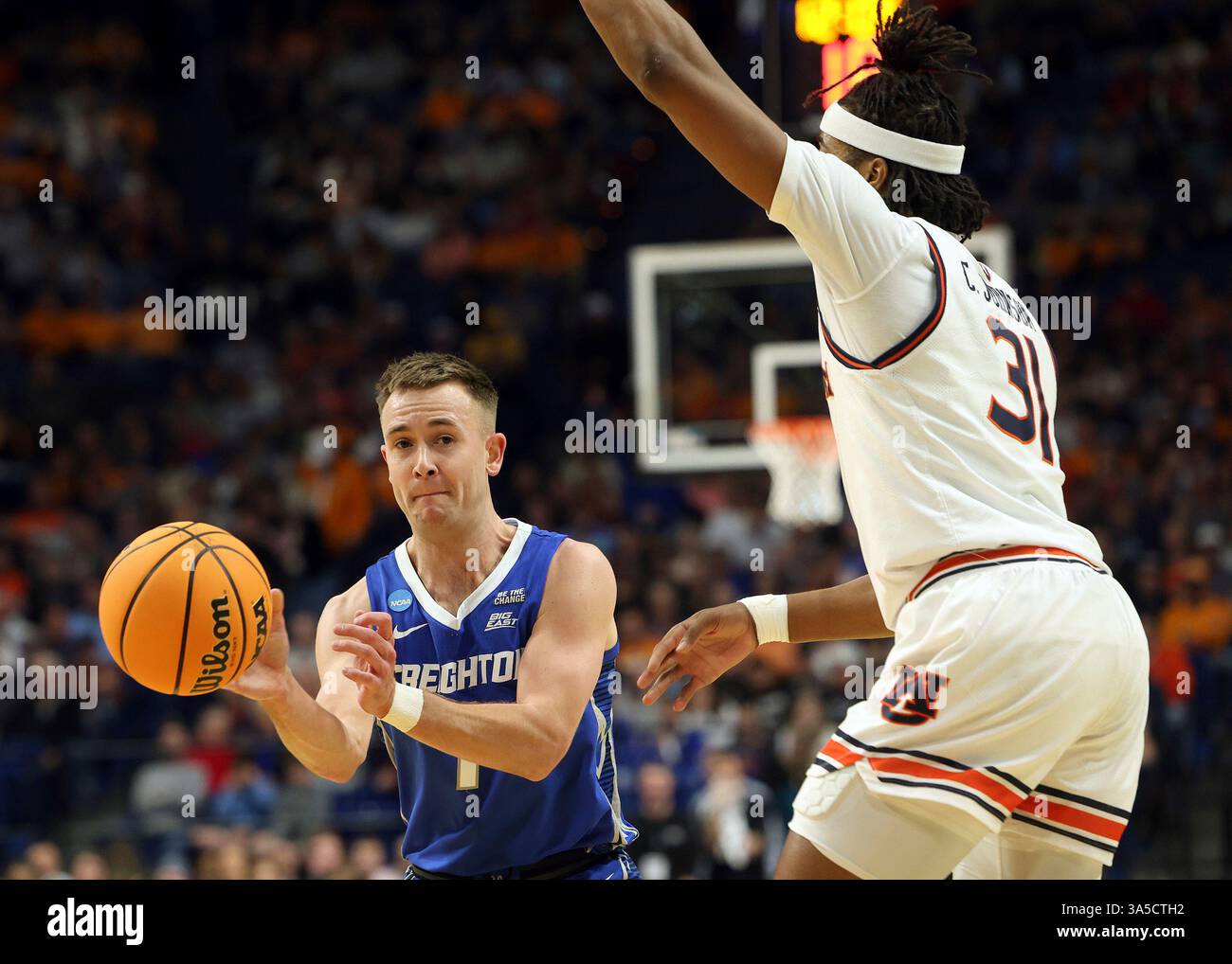 Creighton's Steven Ashworth (1) passes around Auburn's Chaney Johnson ...