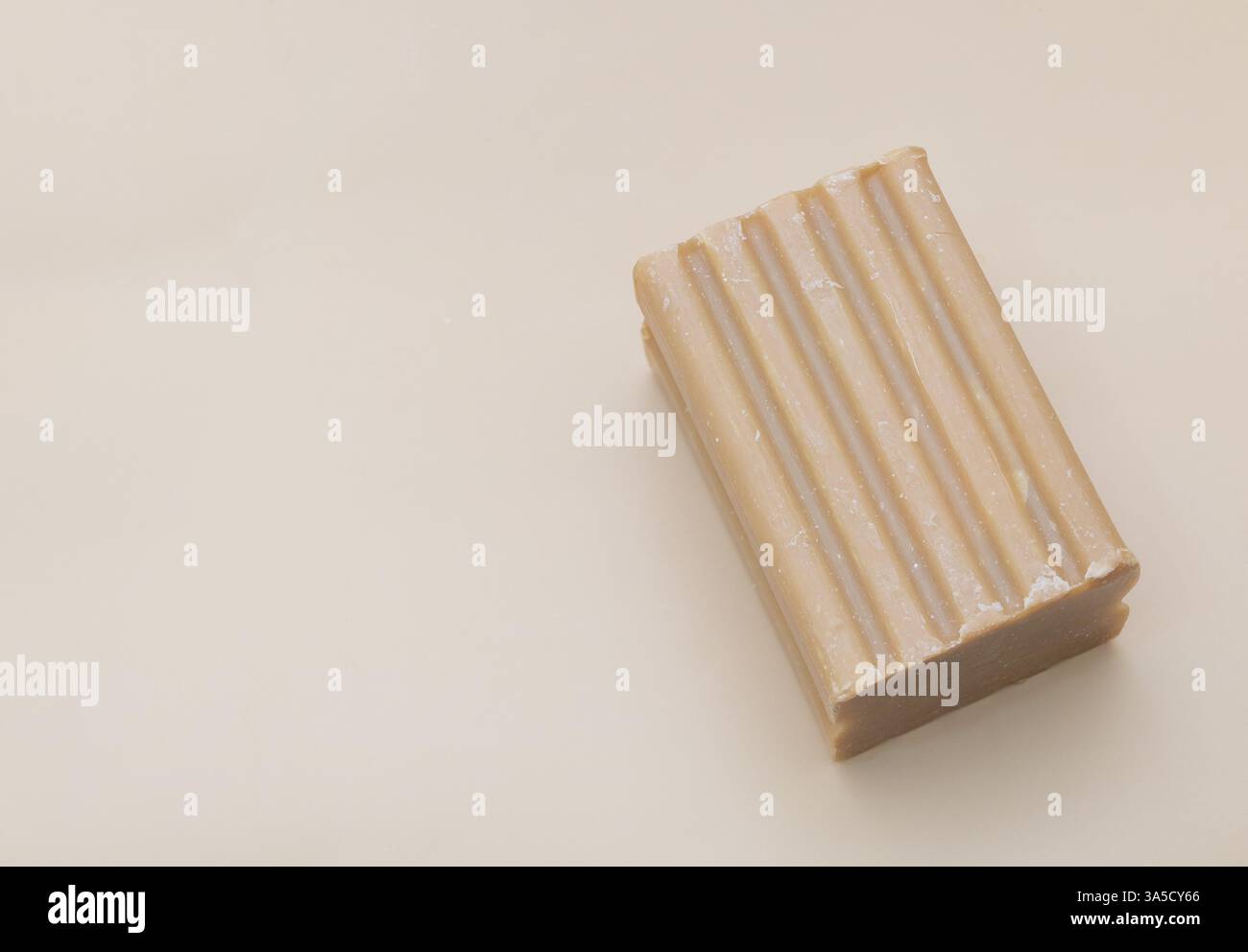 Bar of soap with vertical grooves on the surface, on an isolated white ...
