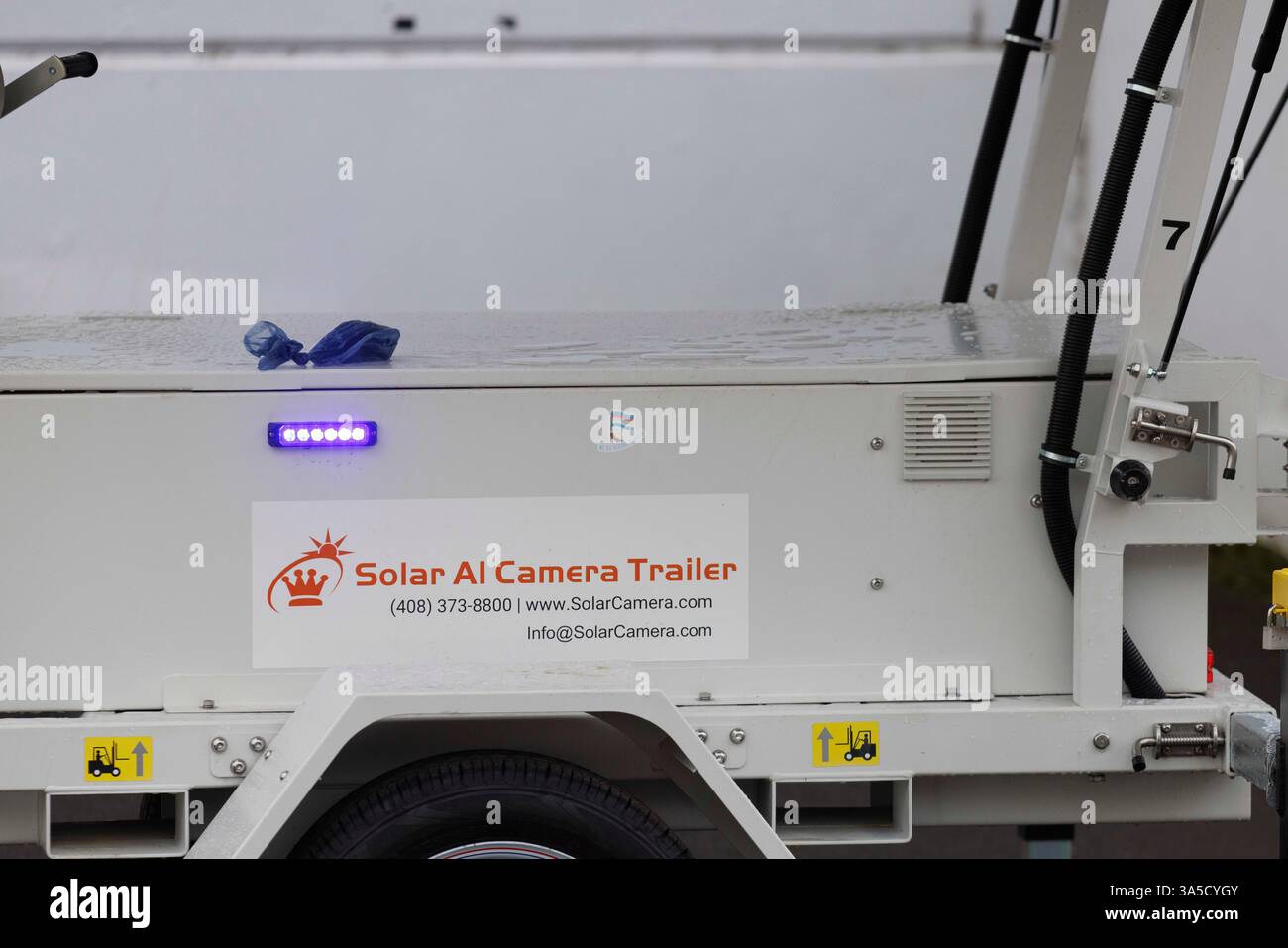 A solar-powered security camera watches over the Tesla dealership.About ...