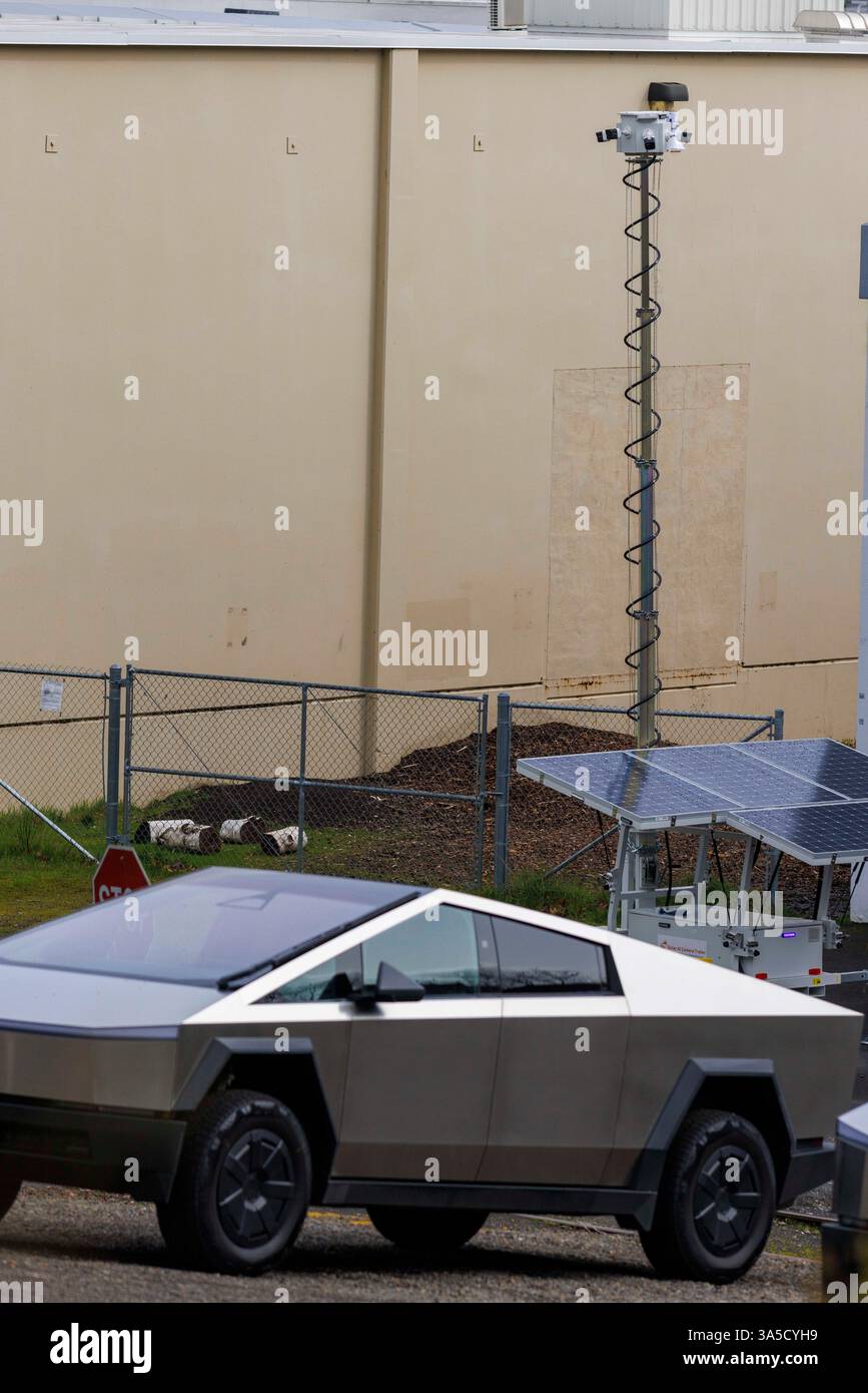 A solar-powered security camera watches over the Tesla dealership.About ...