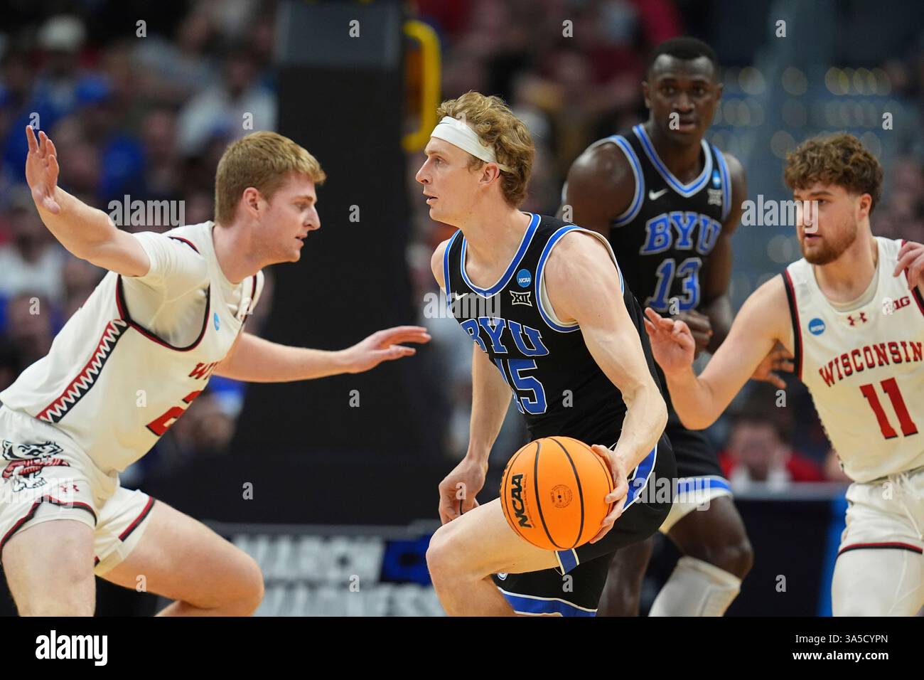 Brigham Young forward Richie Saunders, center, drives between Wisconsin ...