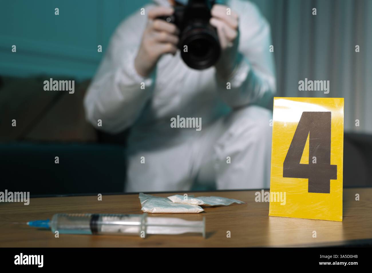 Forensic expert with camera working at crime scene indoors, focus on ...