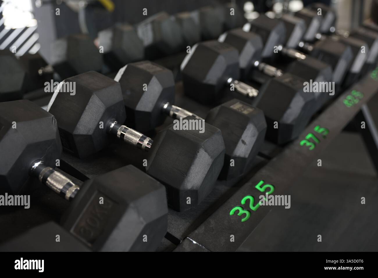 Different many dumbbells in gym. Sport equipment Stock Photo - Alamy