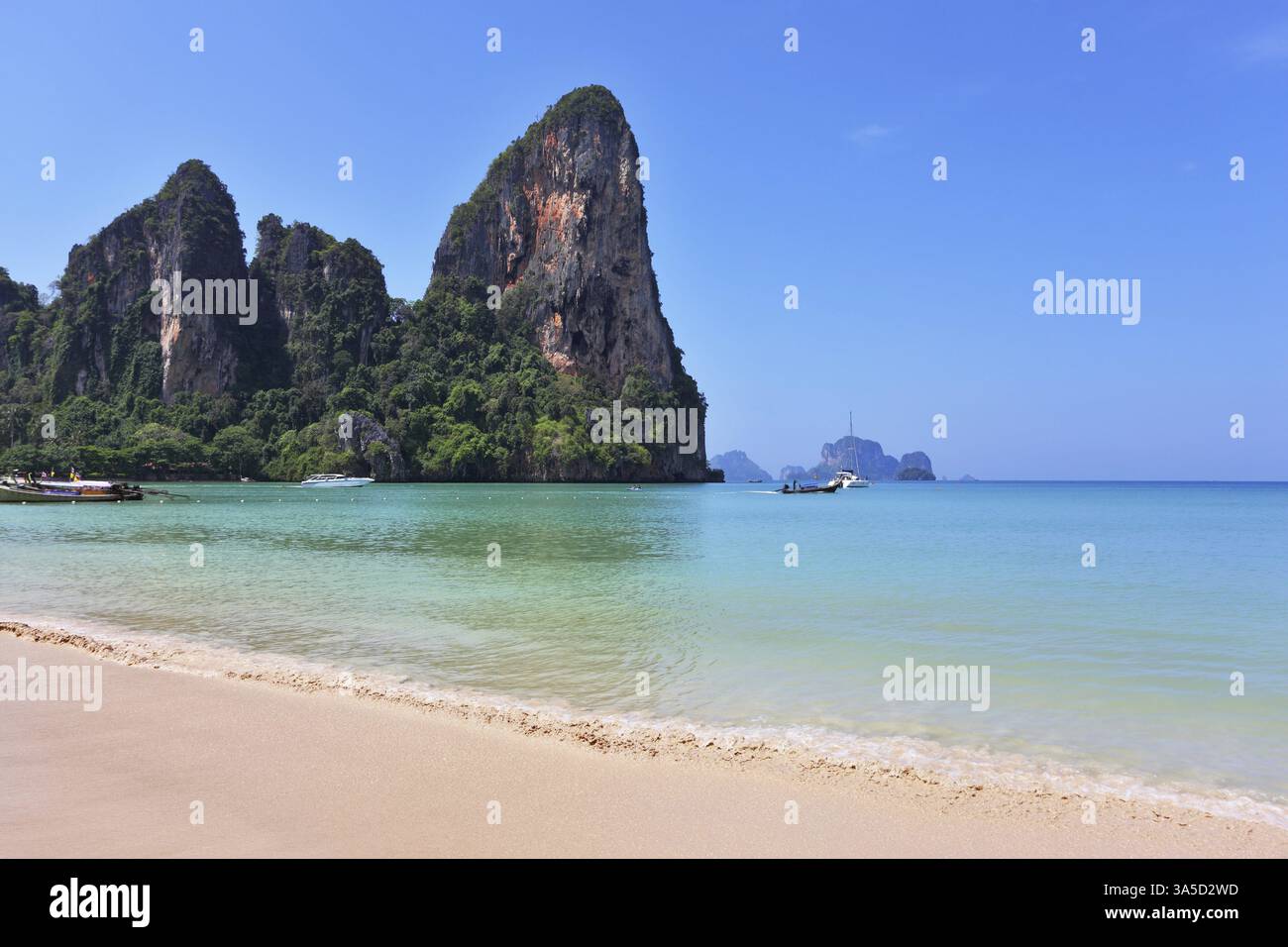 Charming resort landscape. White sand on a beach, rocks and picturesque ...