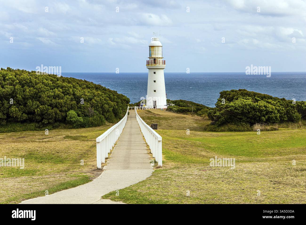 The path to the lighthouse is fenced with a railing. Magnificent snow ...