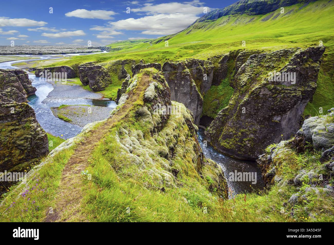 Vertical huge rocks surround the stream with glacial water. The concept ...