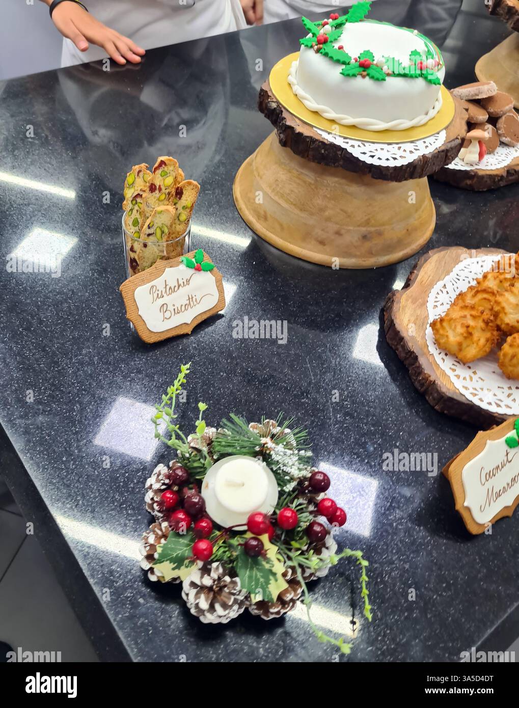 Various bakery items showcased on a dark countertop during a festive ...