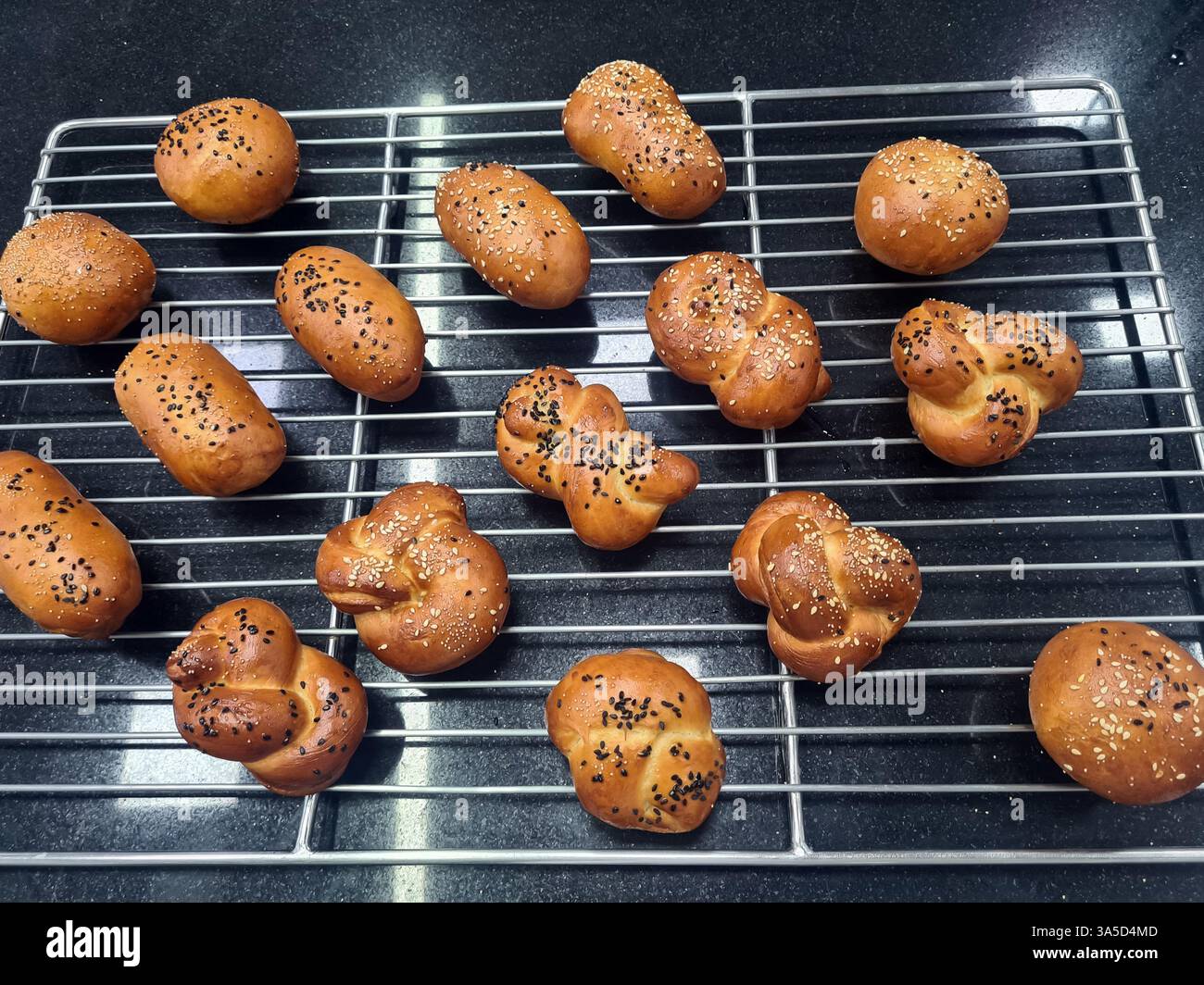 Bakery products are placed on a wire rack, allowing them to cool and ...