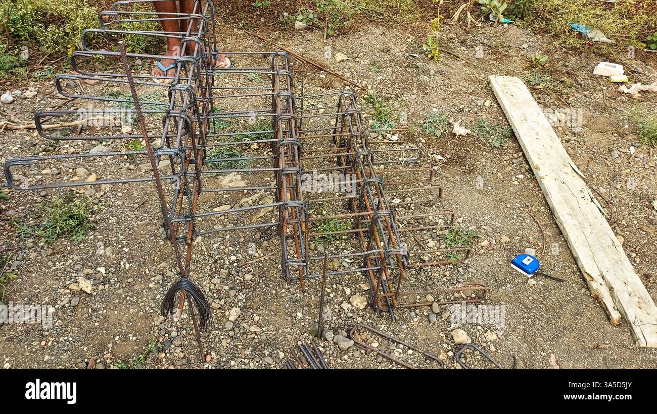 Workers at a construction site are organizing rebar structures on the ...