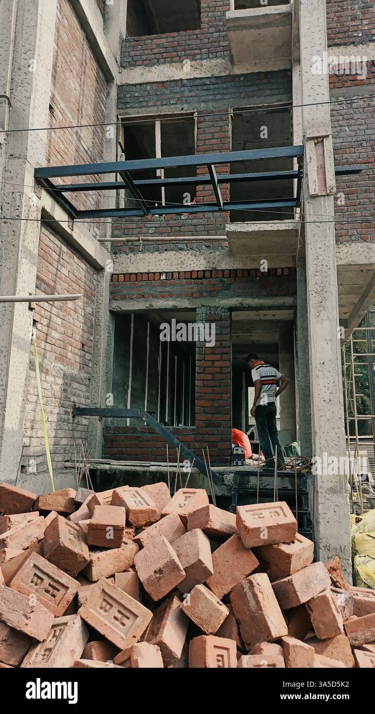 Construction continues on a multi-story building, showcasing workers ...