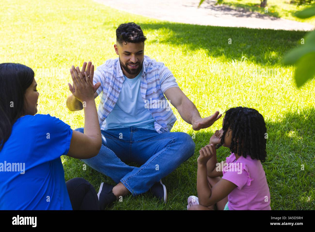 Family enjoying outdoor bonding time, playing games and sharing ...