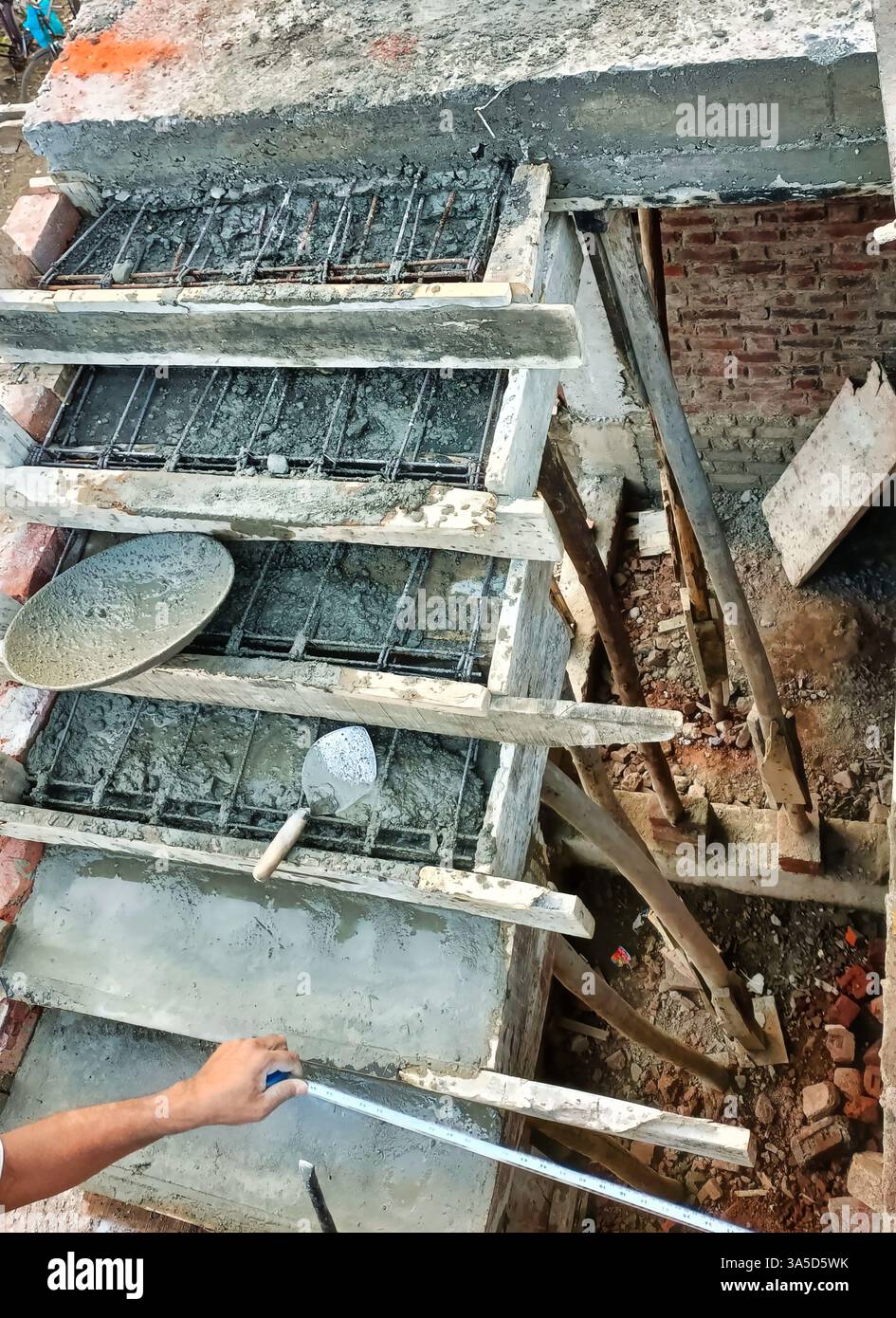 Workers are constructing a reinforced concrete slab on a building site ...