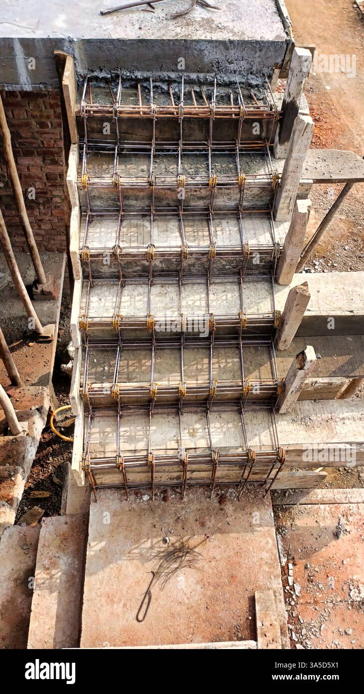 Workers are constructing a set of reinforced concrete stairs ...