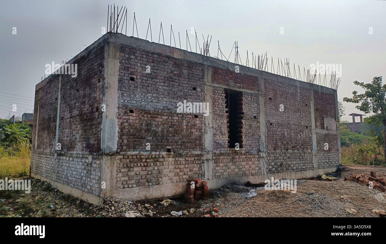 Construction continues on a solid brick structure featuring exposed ...
