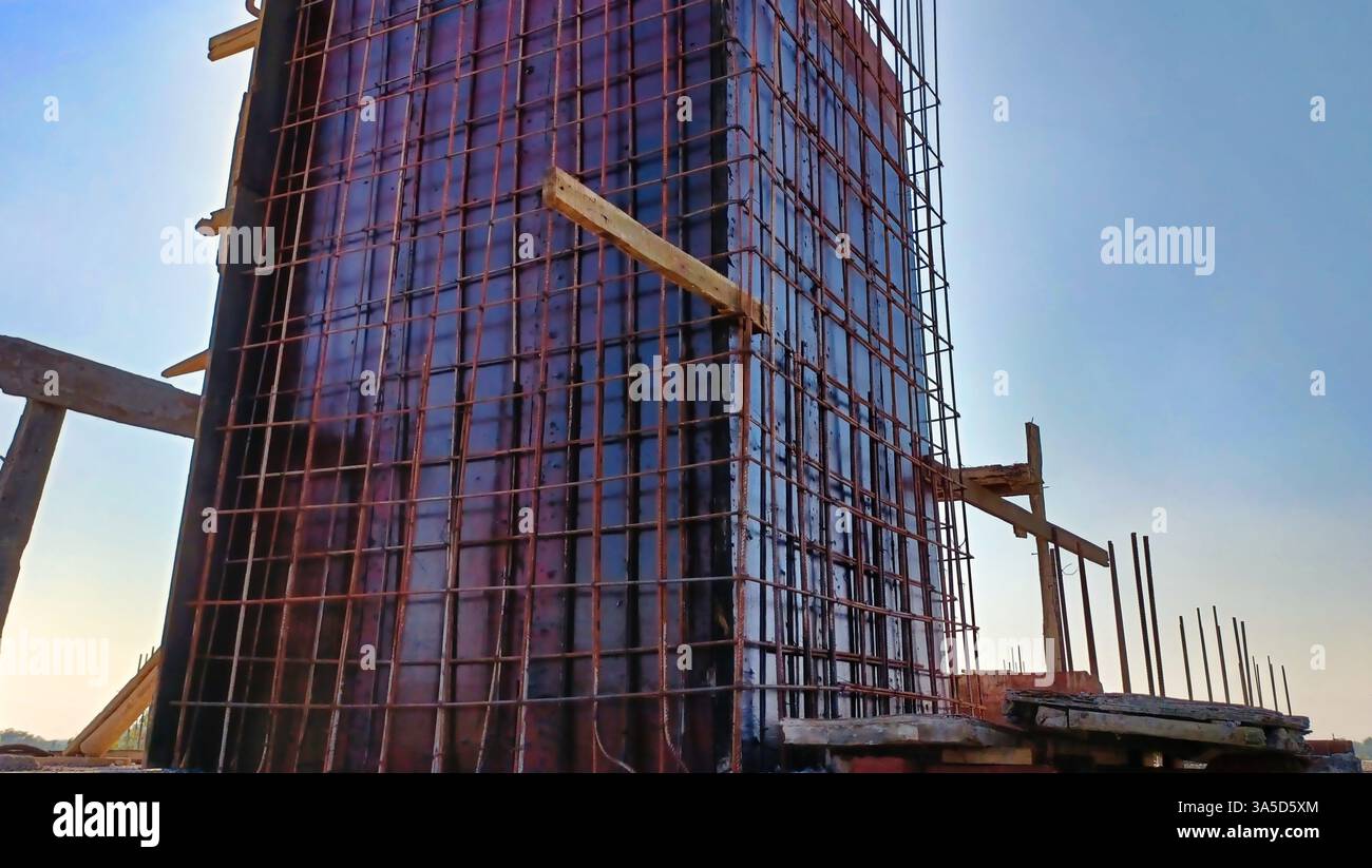 Construction workers install formwork for a concrete structure on a ...
