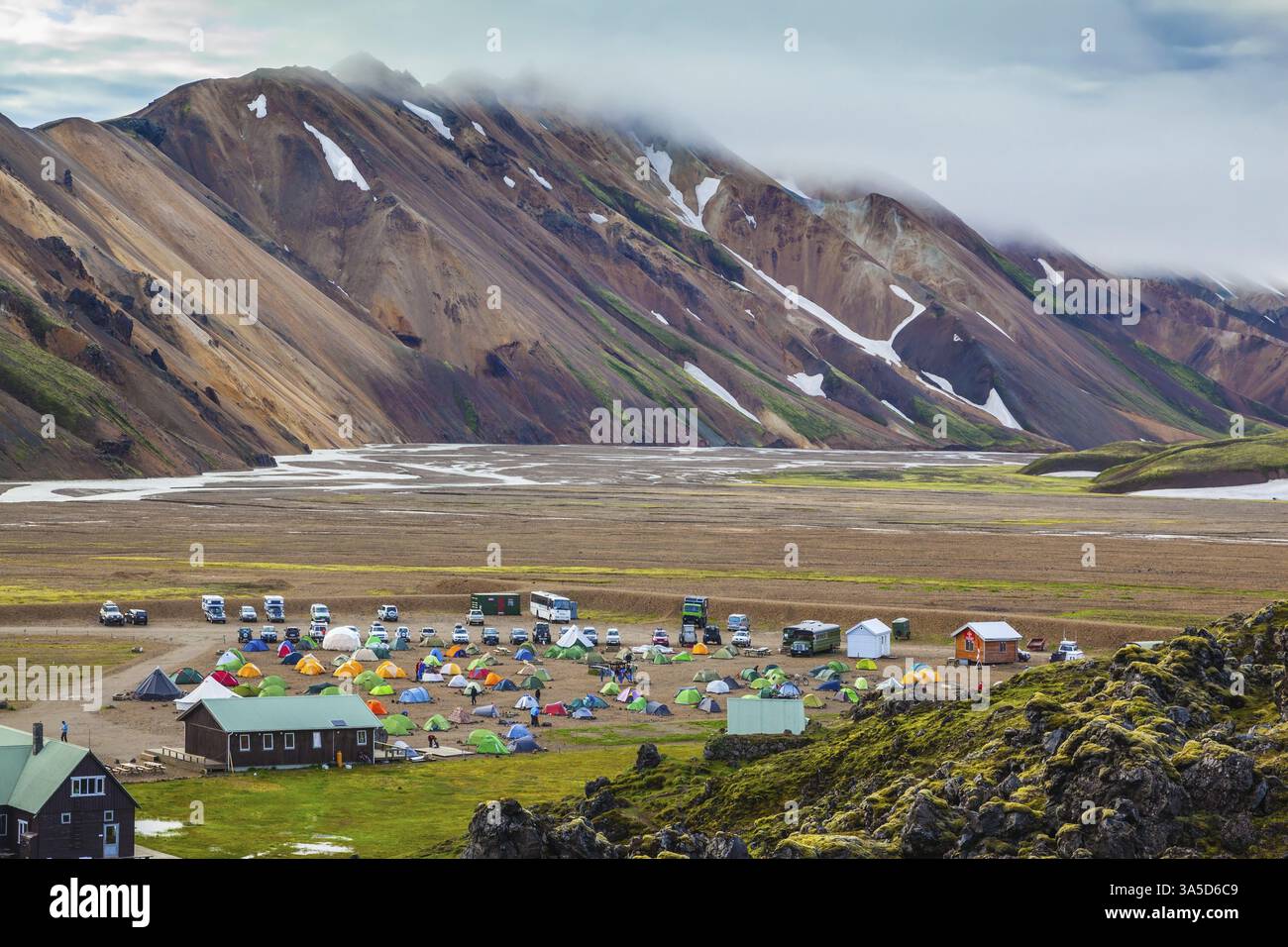 Pink and green rhyolite mountains surround the flat valley of the ...