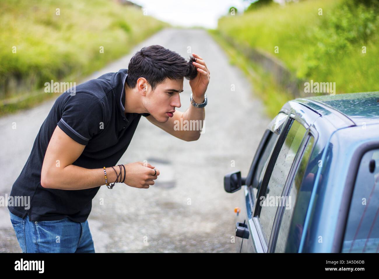 Half Body Shot of a Handsome Young Man Looking at His Reflection on a ...